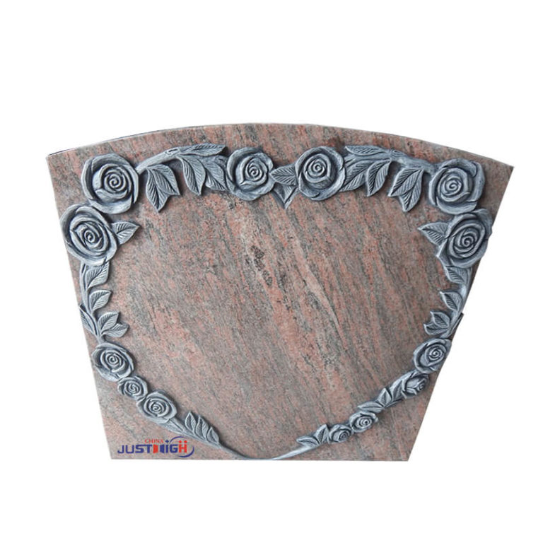 Red granite headstone with flower carving