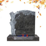 Carved granite tombstone in tree trunk shape