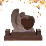 Angel hugging heart shaped tombstone red granite headstone
